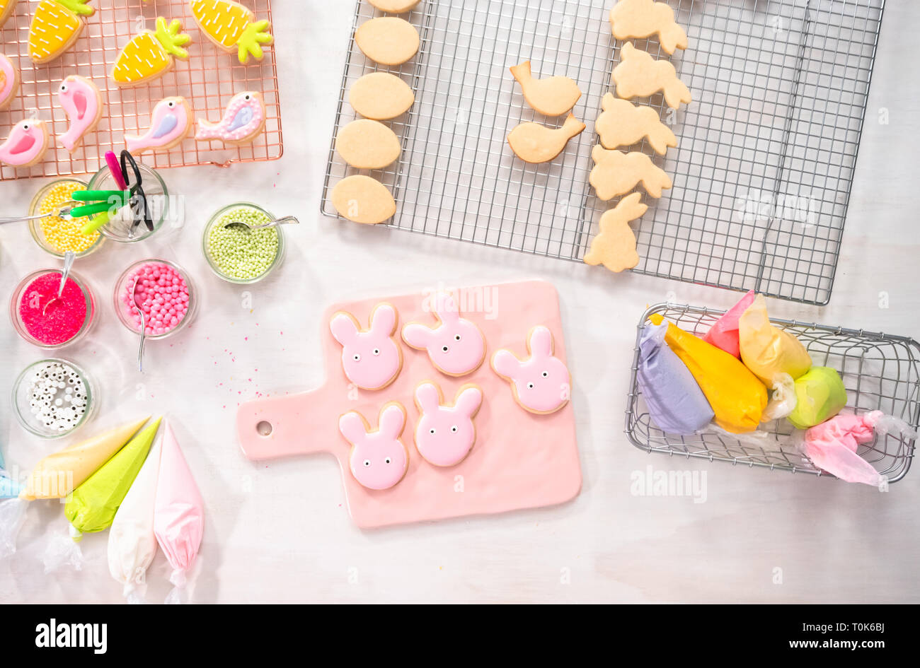 Flat lay. Decorating Easter sugar cookies with rotal icing Stock Photo ...