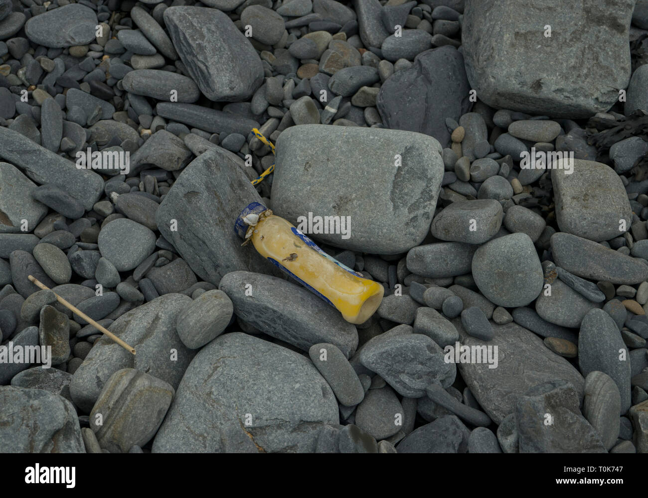 Plastic waste left on the pebbles of a beach in Ceredigion, mid Wales ...