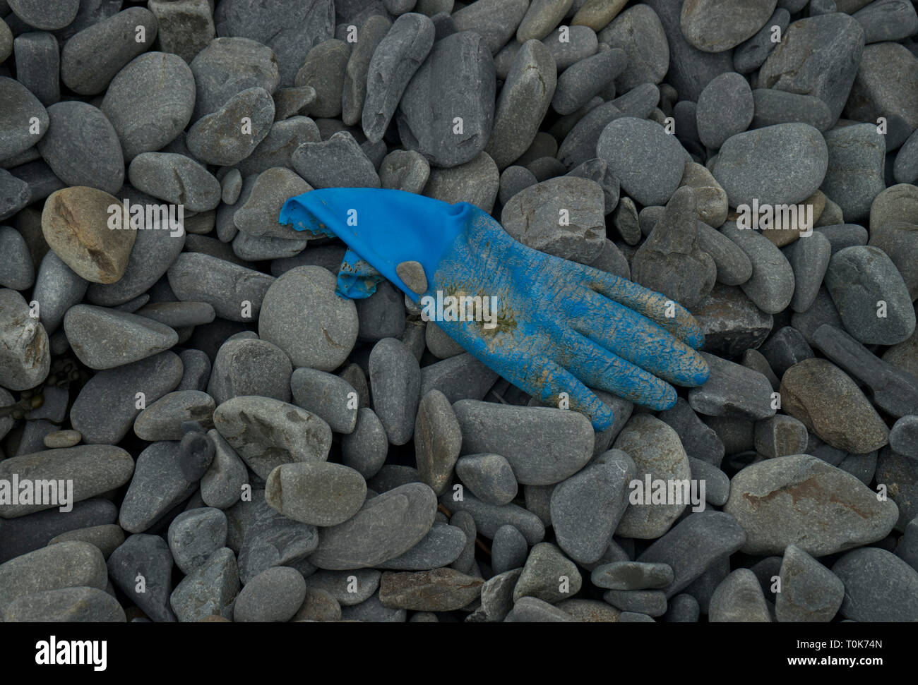 Plastic waste left on the pebbles of a beach in Ceredigion, mid Wales ...
