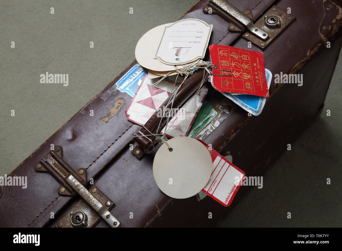 Vintage Suitcase with old Travel Labels Stock Photo - Alamy