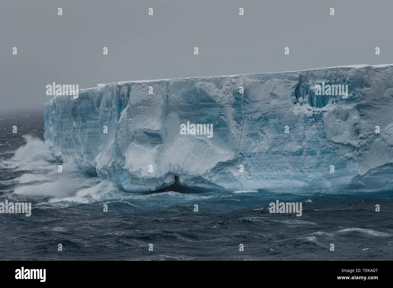 Frosted Iceberg in open water with water splashing Stock Photo - Alamy