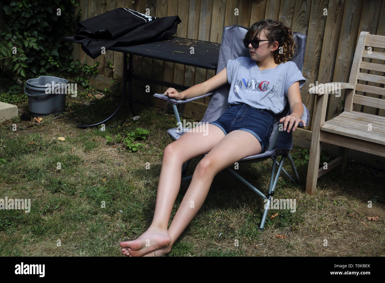 Teenager Sitting on Chair in Garden Gillingham Dorset England Stock ...