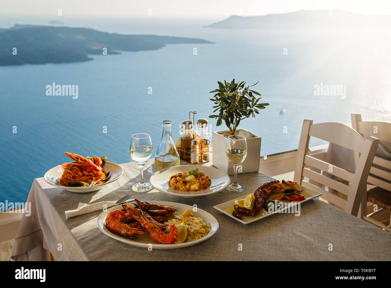 Romantic dinner for two at sunset.Greece, Santorini, restaurant on the ...