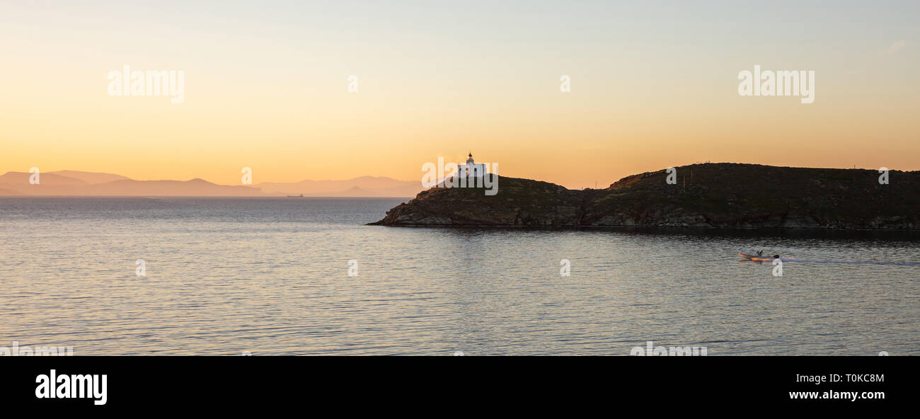 Greece, Kea island. Seascape with lighthouse at sunset, clear dark sky ...