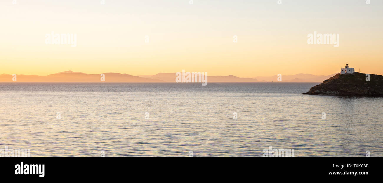 Greece, Kea island. Seascape with lighthouse at sunset, clear dark sky ...