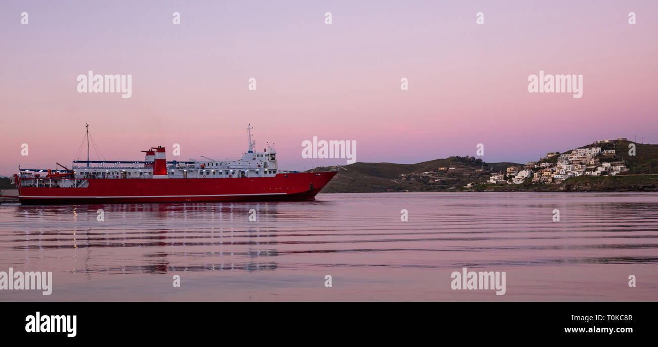 Greece, Kea island at sunset. Seascape with a red ferry boat at ...