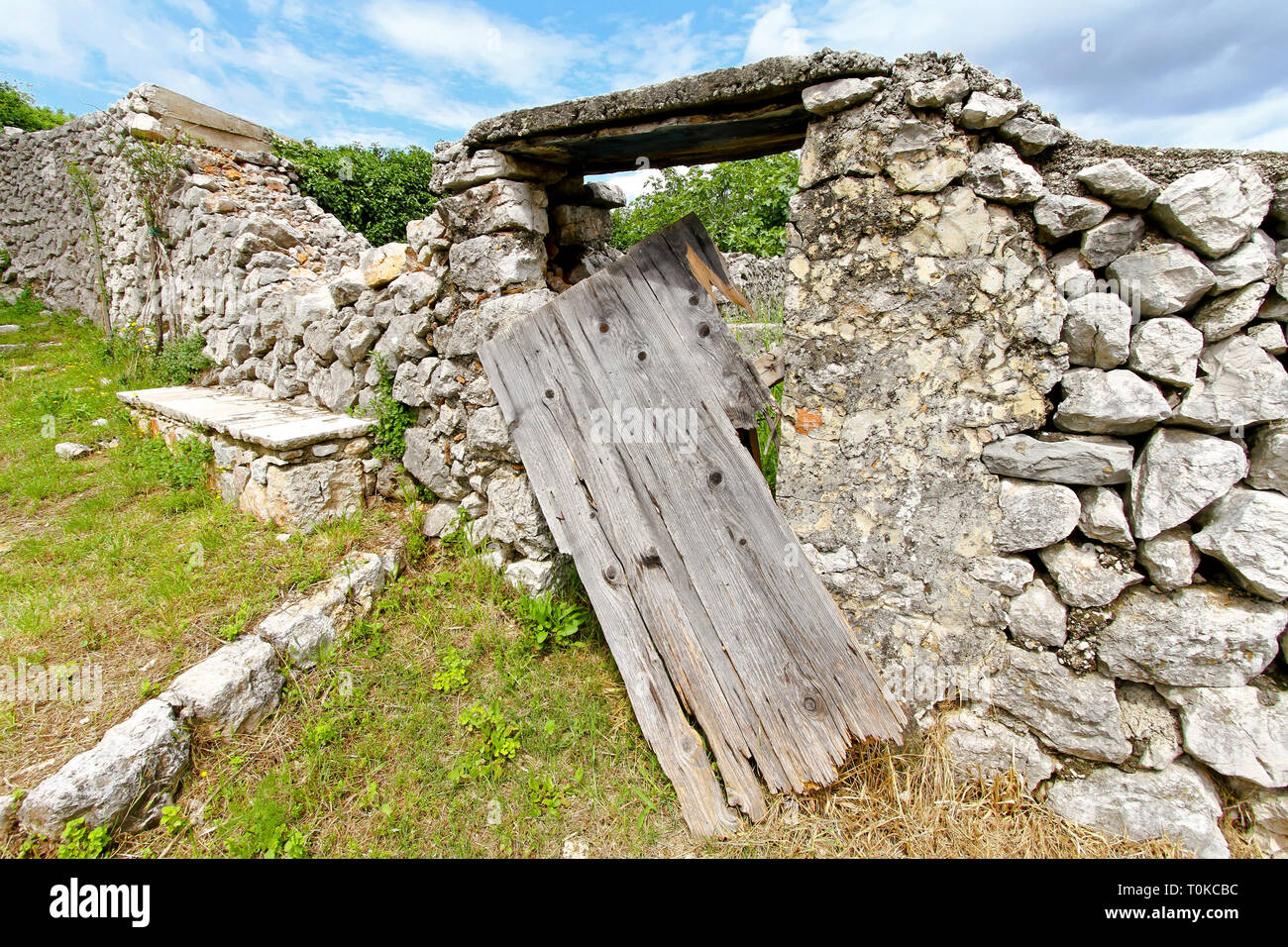 Derelict property with wooden door bad condition Stock Photo - Alamy