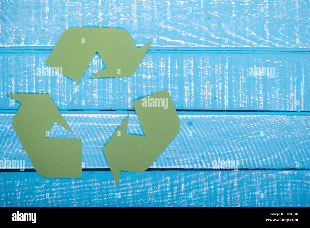 Recycle concept showing the green recycle logog on a blue weathered ...