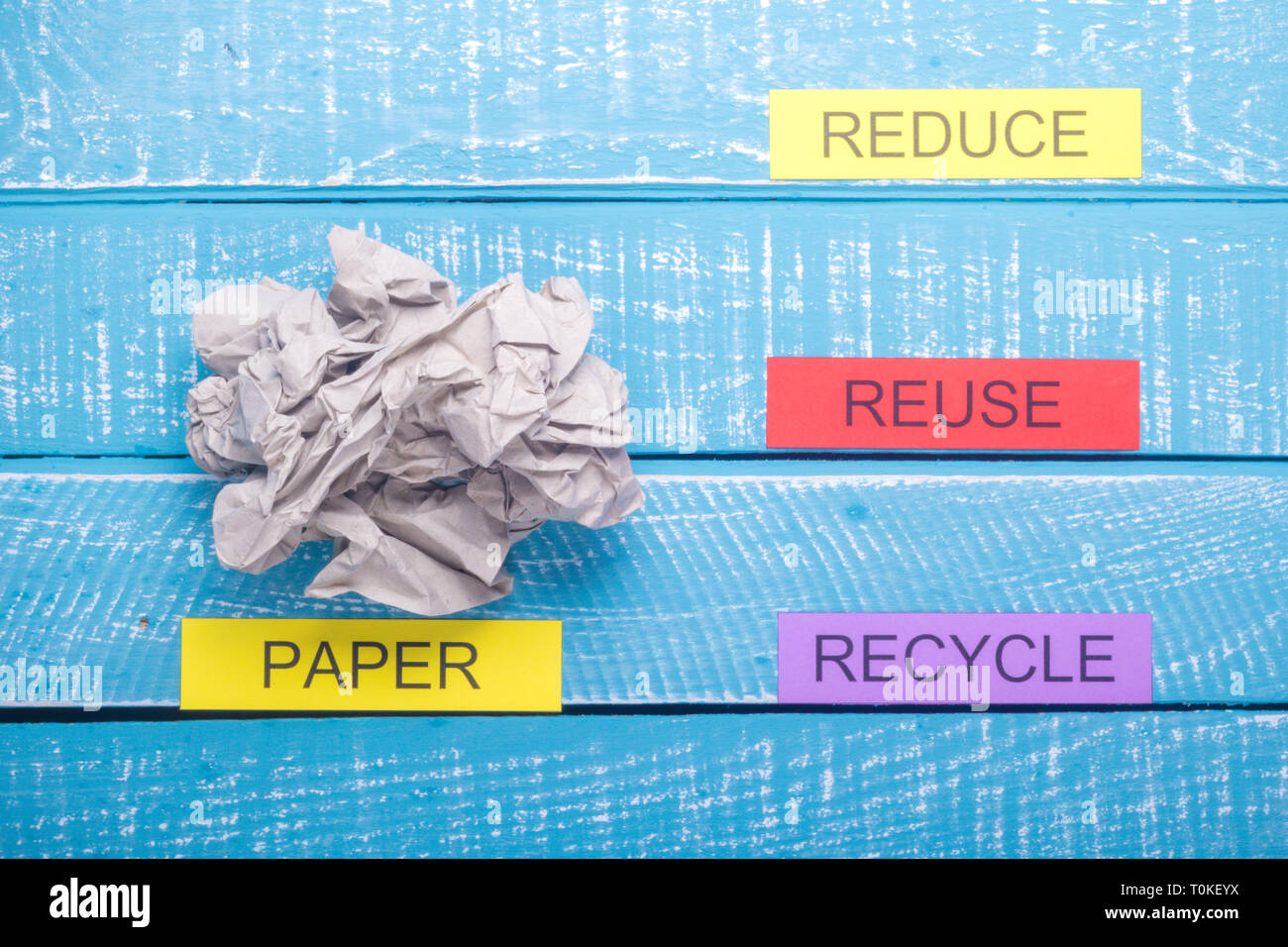 Recycle concept showing paper with reduce, reuse & recycle on a blue ...