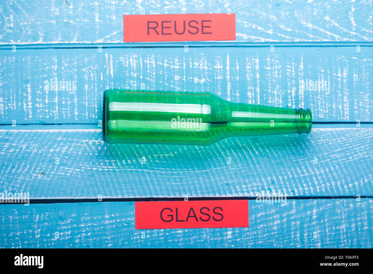Recycle concept showing glass & reuse on a blue weathered background ...