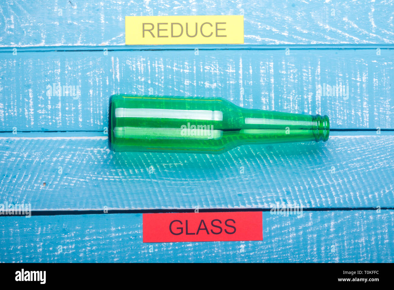 Recycle concept showing glass & reduce on a blue weathered background ...