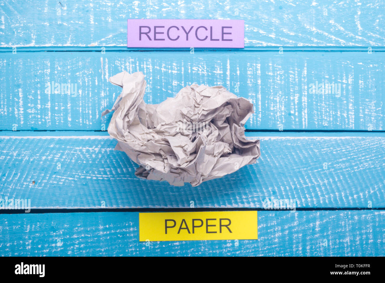Recycle concept showing paper & recycle on a blue weathered background ...