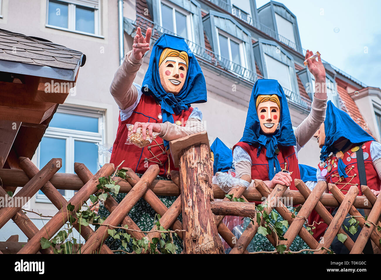 Carnival figures on a cart with wooden fence. Street Carnival in ...