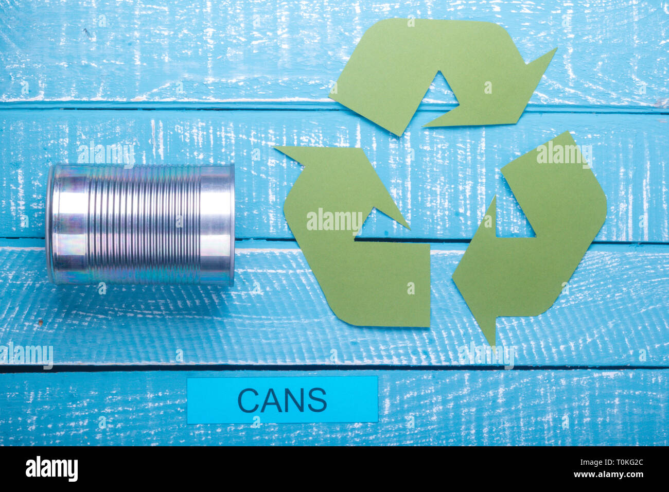 Recycle concept showing green recylce logo with cans on a blue ...
