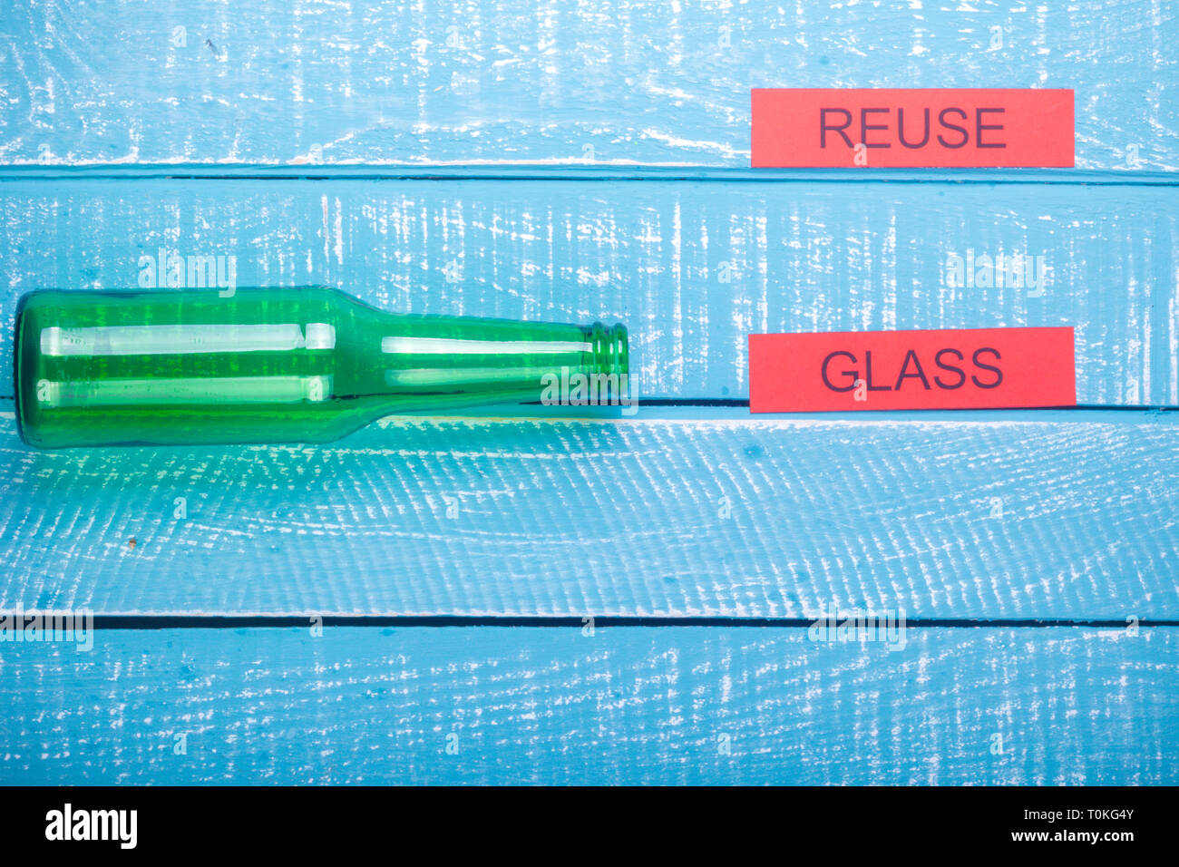 Recycle concept showing reuse glass on a blue weathered background ...