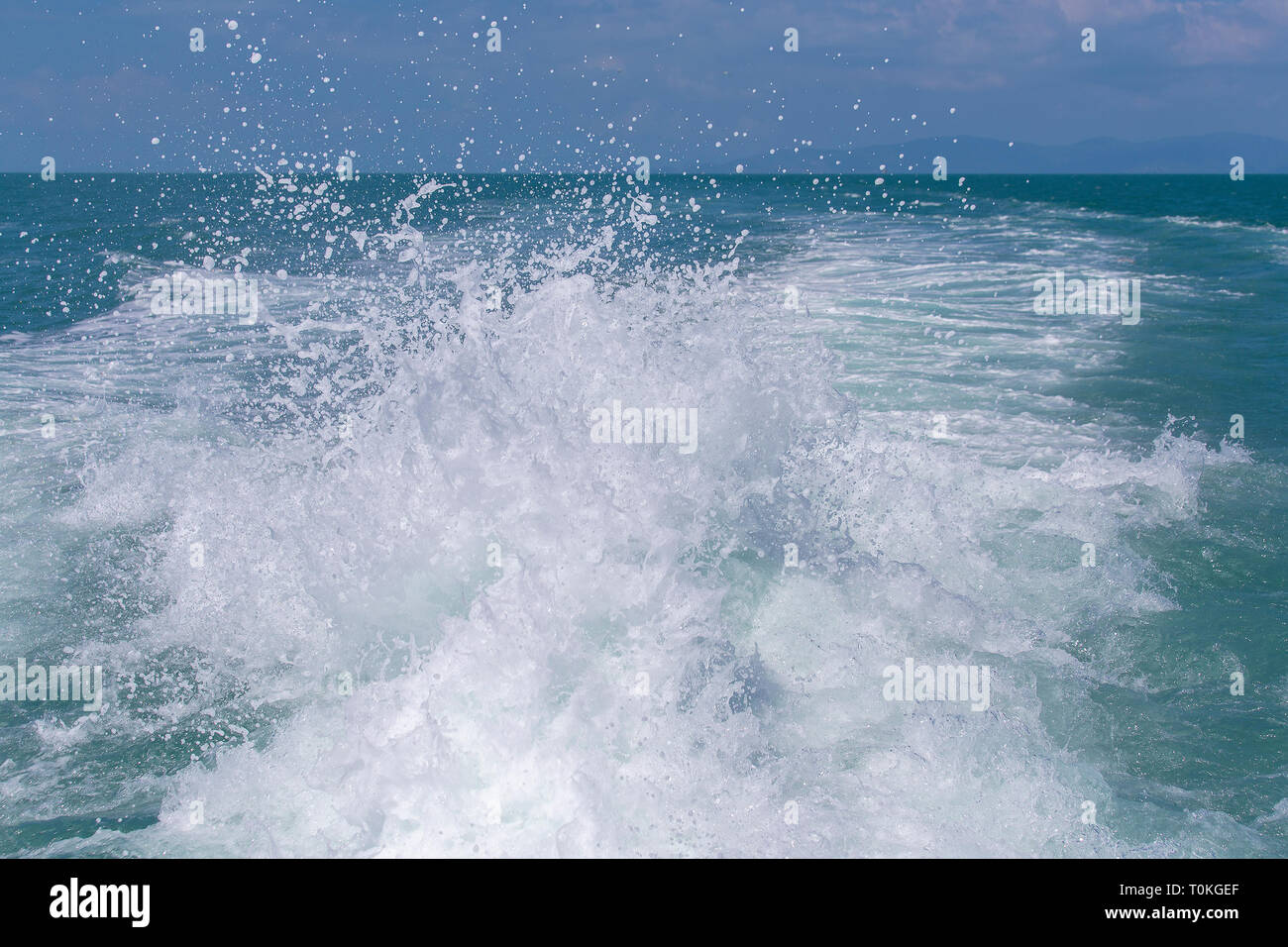 Blue ocean sea water wave with fast yacht boat wake foam of prop wash ...