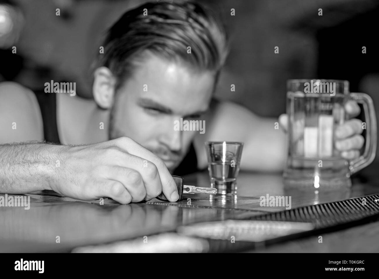 Do not drive drunk. Man drinker with car keys in pub. Handsome man ...