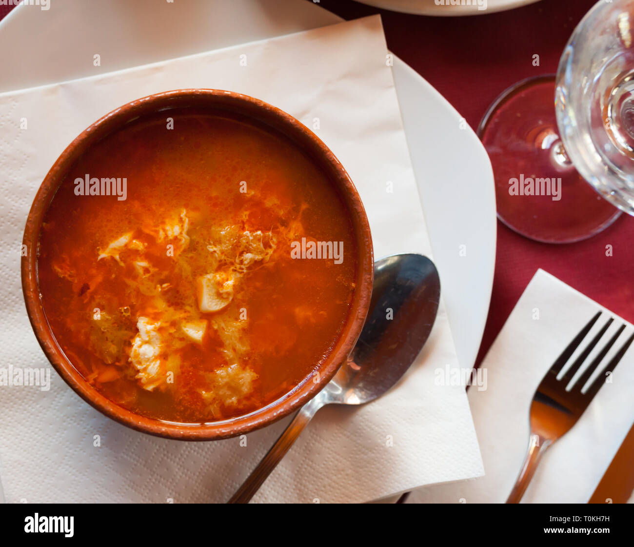 Top view of clay bowl of Castilian garlic soup rich with bread, stringy ...