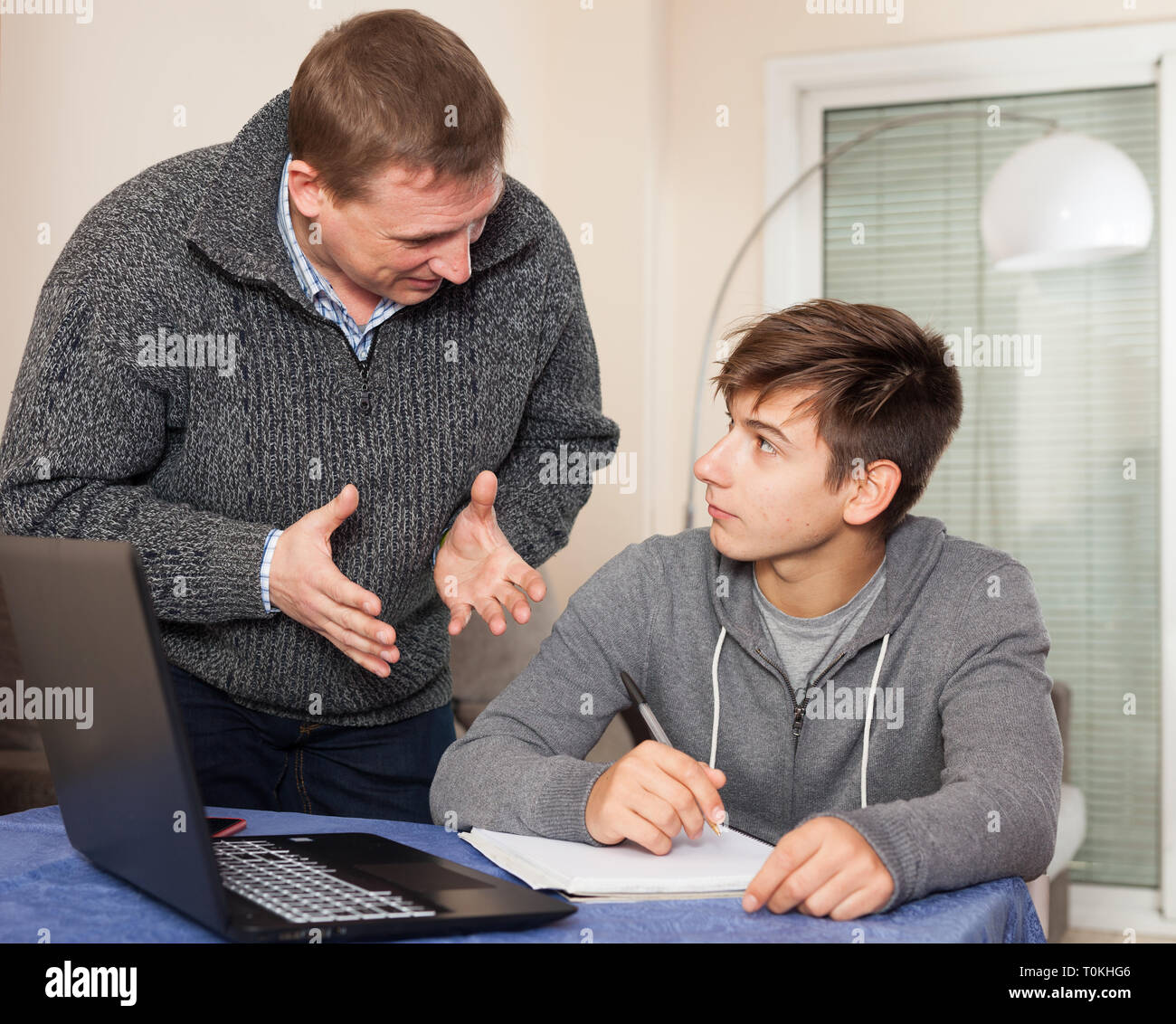 Father scolds son for poor grades in school Stock Photo - Alamy