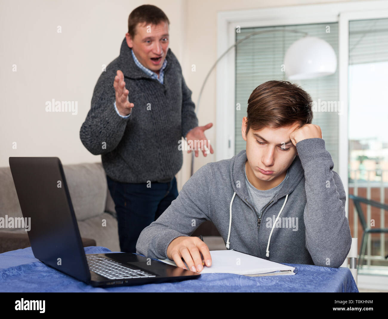 Father scolds his son for bad schooling Stock Photo - Alamy