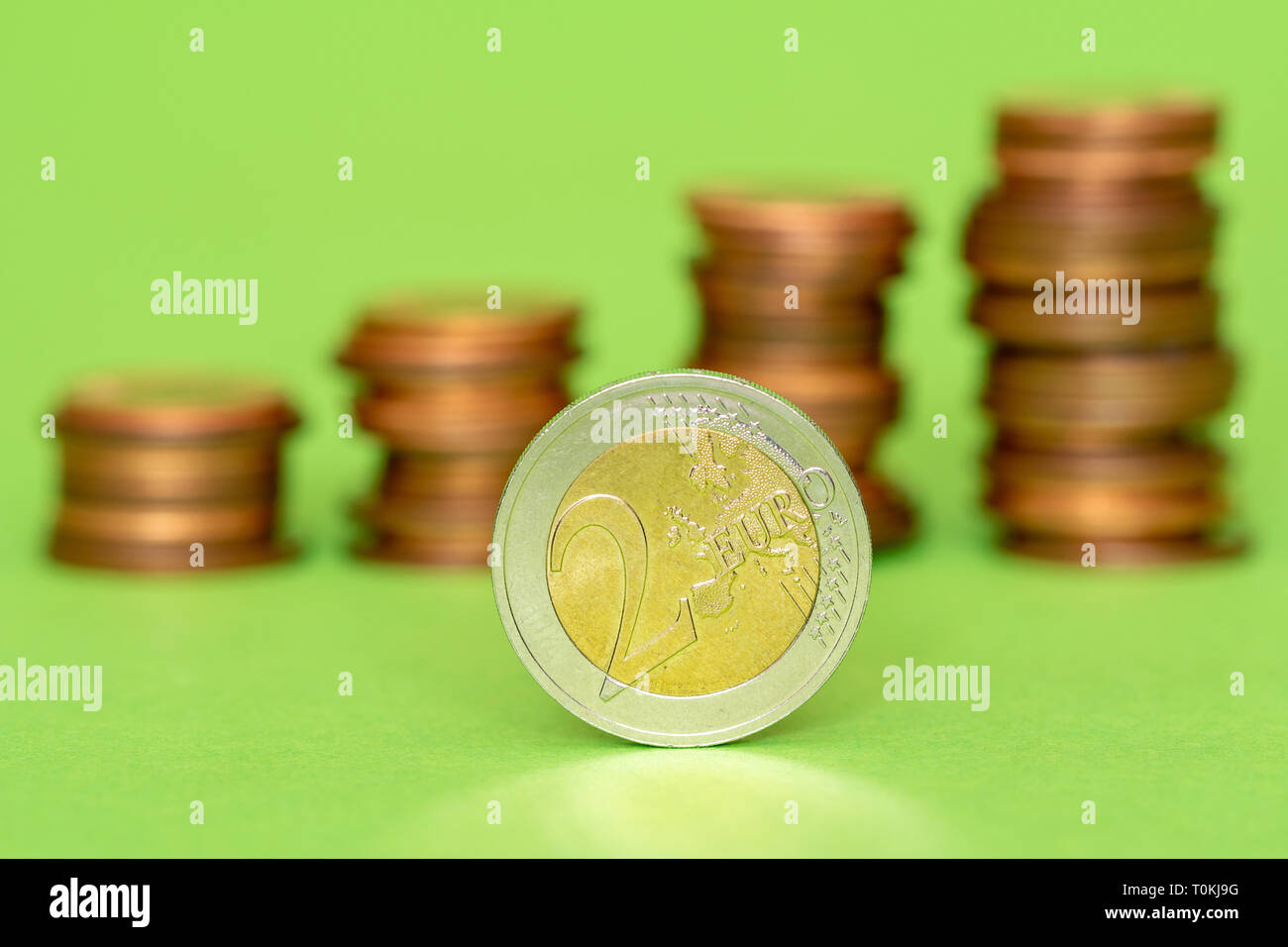Two euro coin with other coins stacked in the background Stock Photo ...