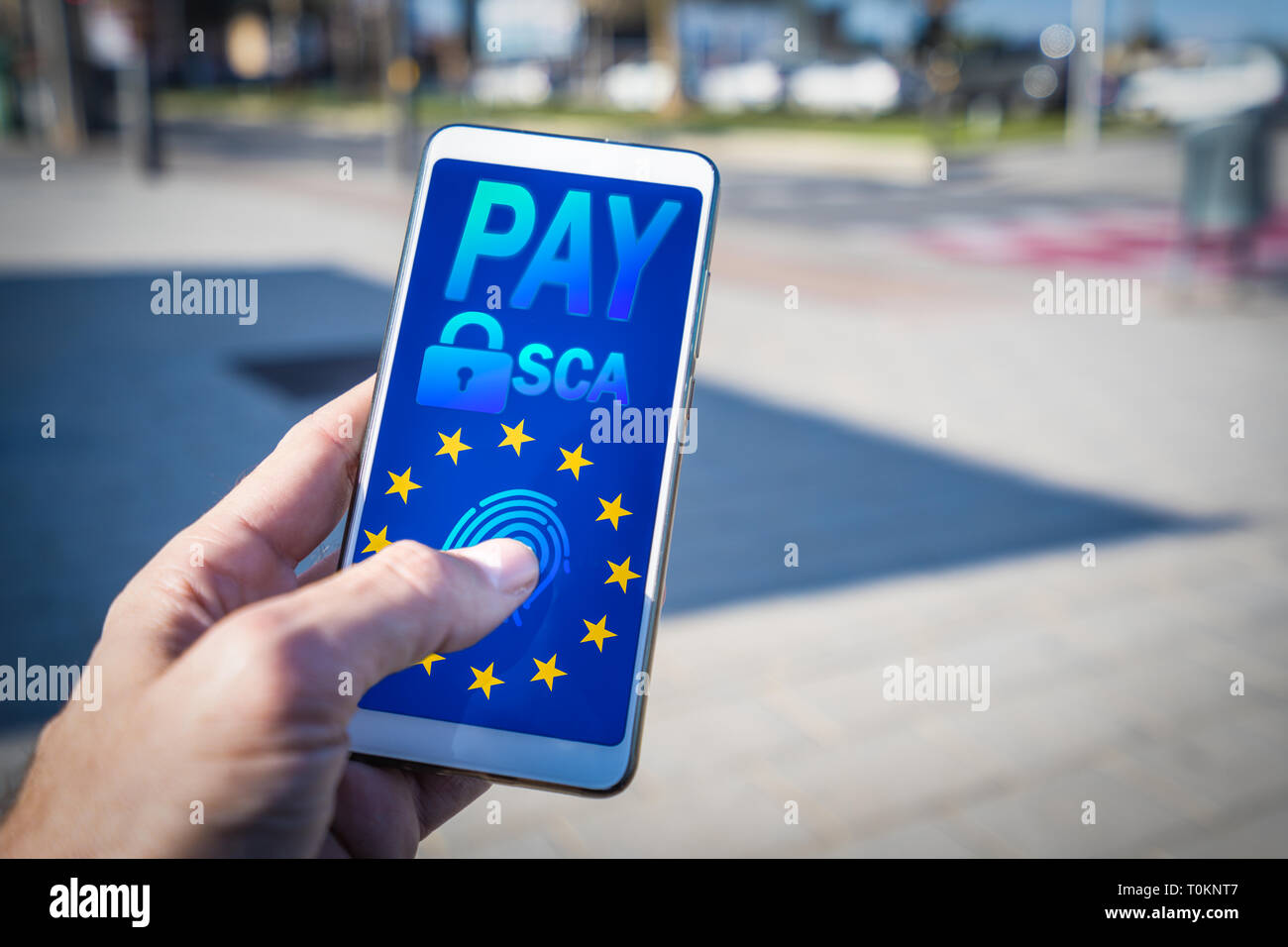 Hands using a smartphone with SCA payment on screen Stock Photo - Alamy
