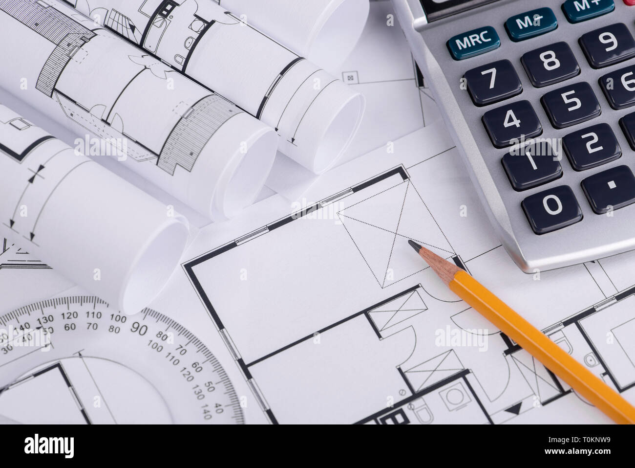 Selective focus image.Several rolls of blueprints on an open blueprint ...
