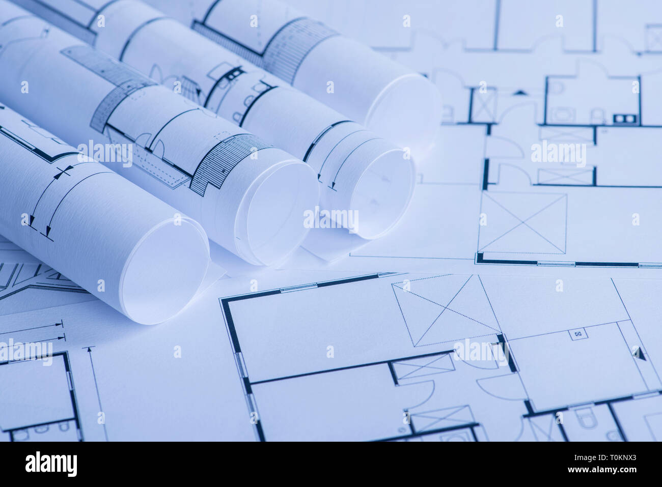 Toned and selective focus image.Several rolls of blueprints on an open ...