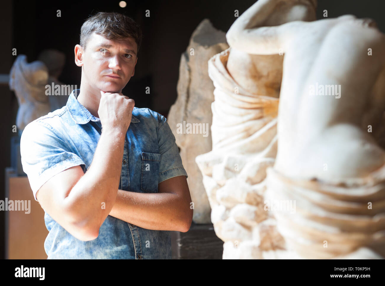 Man visiting sculpture hall in historical museum and looking at ...