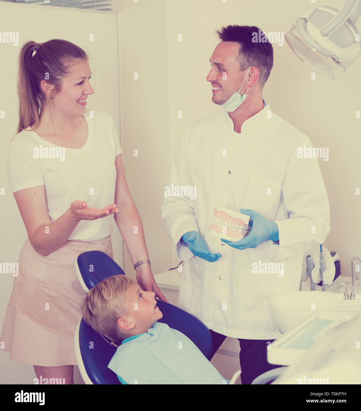 Woman is talking with stomatologist about her child`s health in the ...