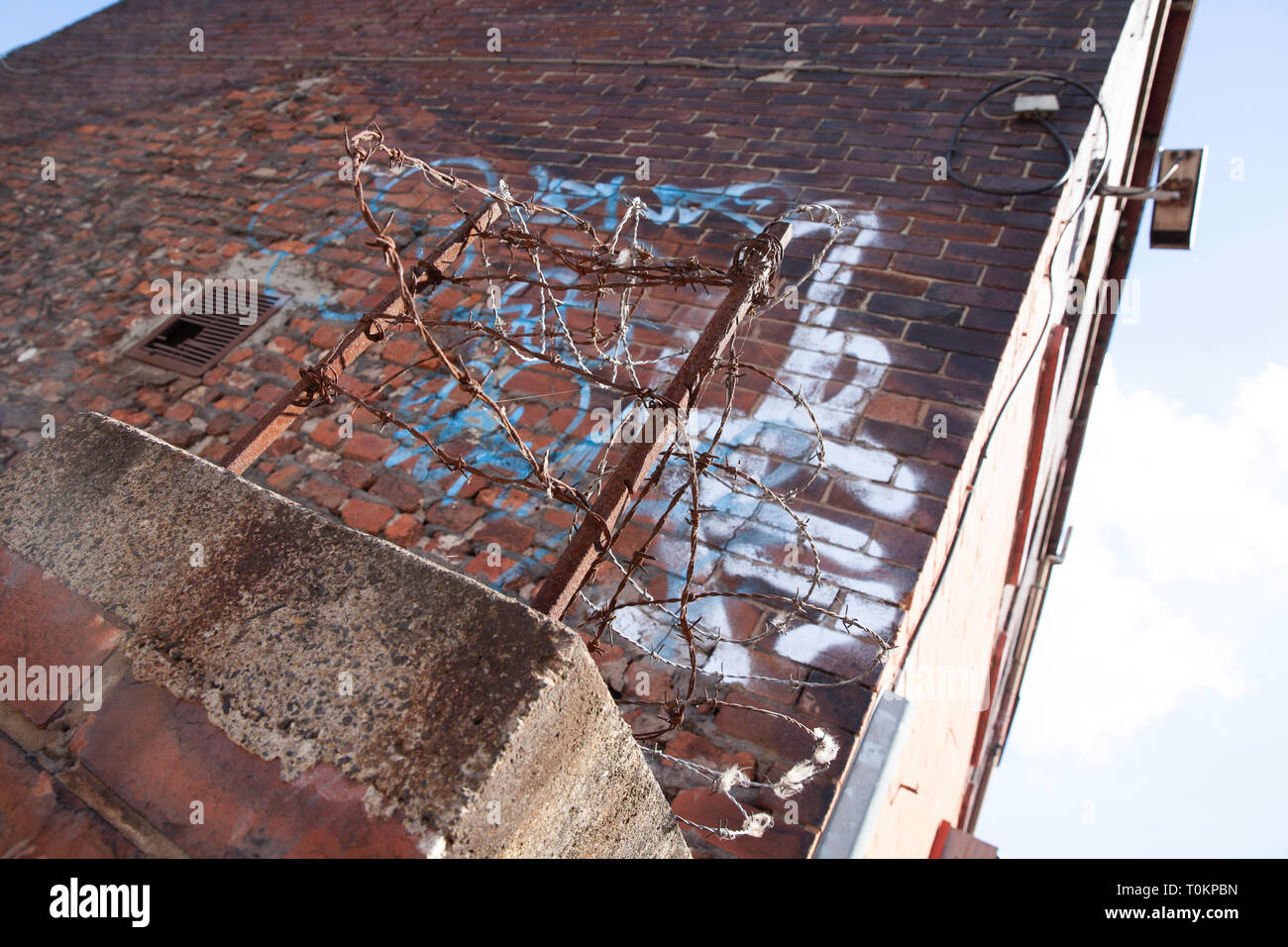 Sheffield graffiti, behind the barbed wire fence Stock Photo - Alamy