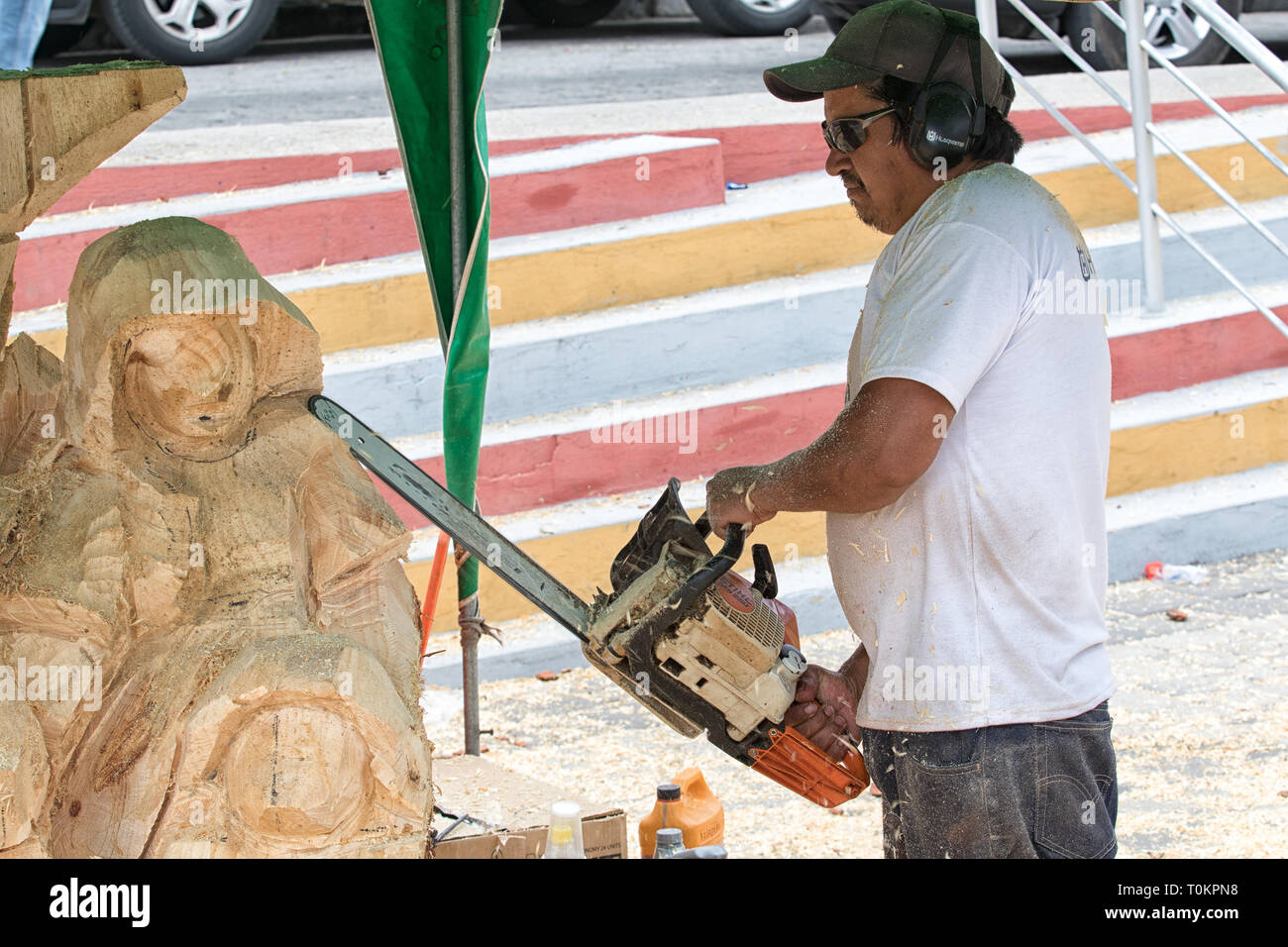 San Antonio de Ibarra, Ecuador - March 3, 2019: man carving wood with a ...