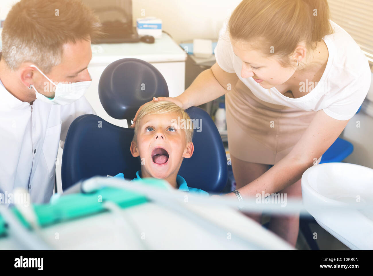Boy with woman are visiting dentist in dental office Stock Photo - Alamy