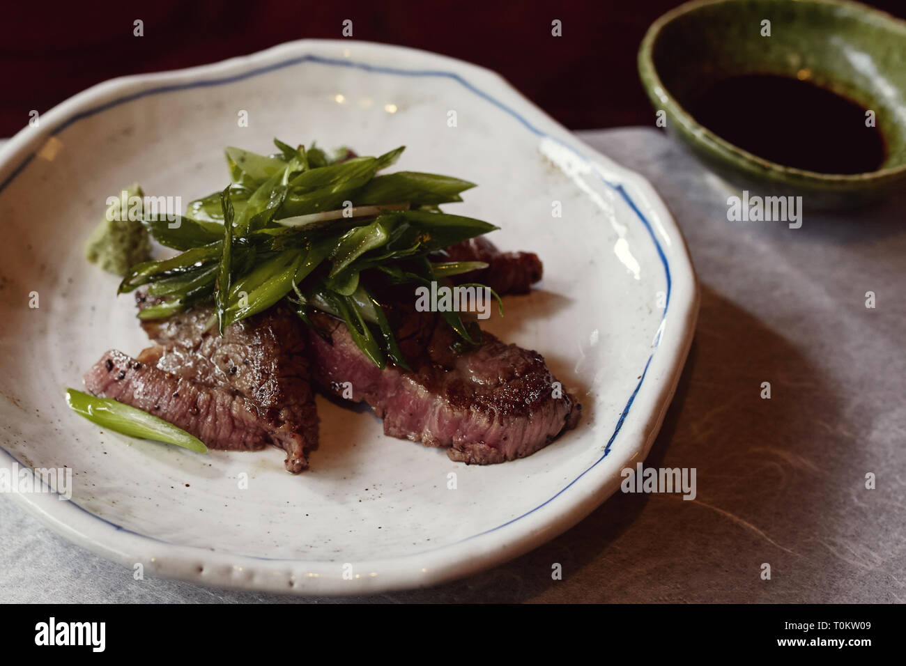 Course of Wagyu beef with scallions and wasabi. This course is part of ...