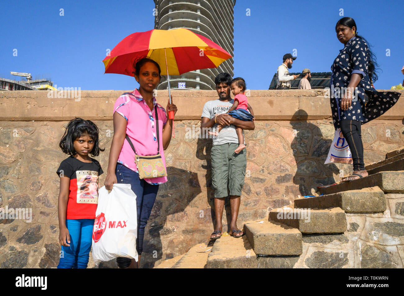Family standing on the steps by the beach, Galle Face Green, Colombo ...