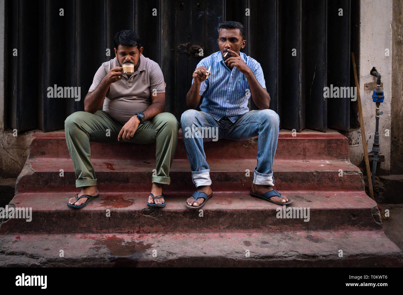 Two men having their morning cigarettes and coffee, Colombo, Sri Lanka ...