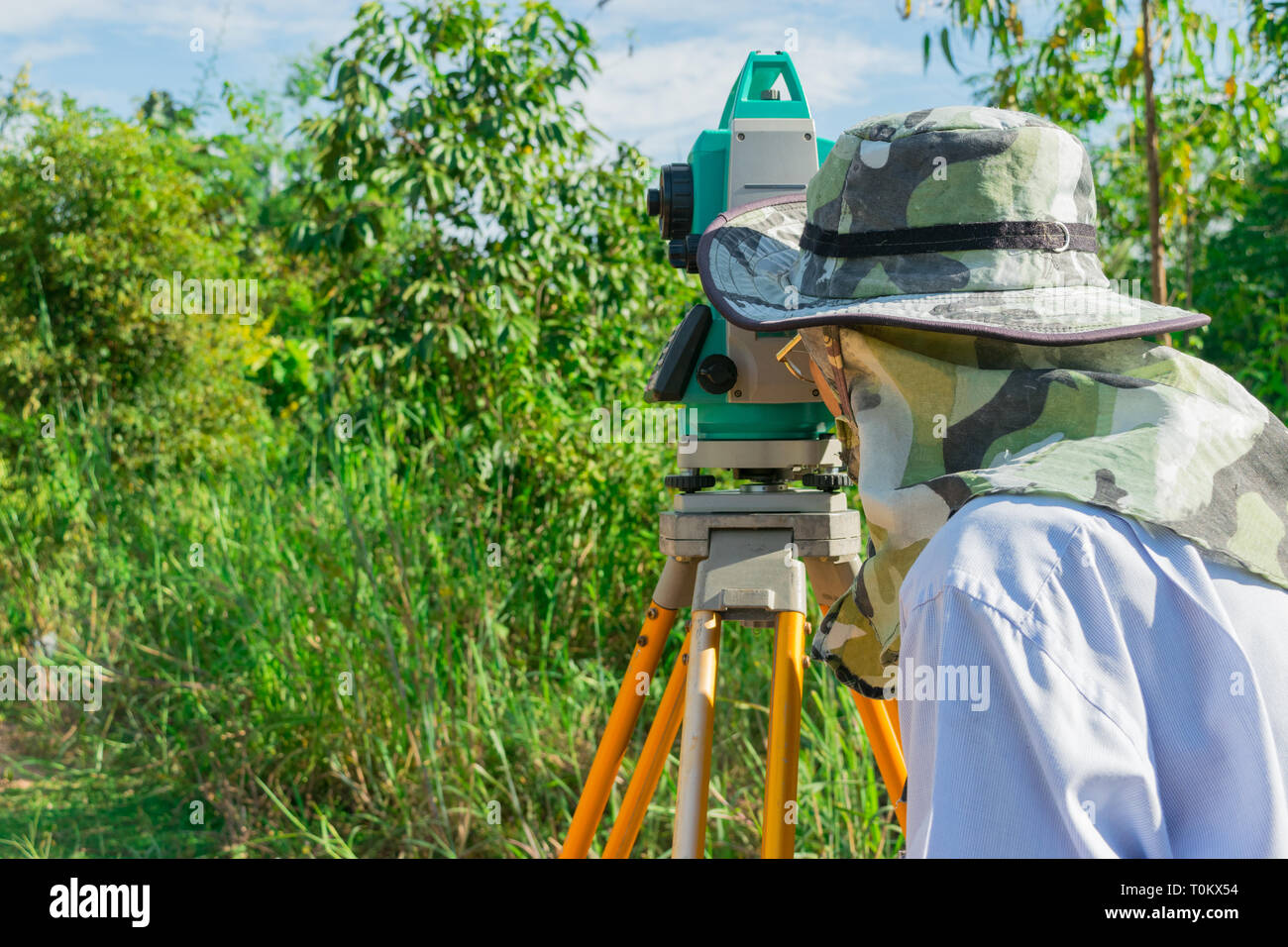engineer is working with level-measuring instrument for survey Stock ...