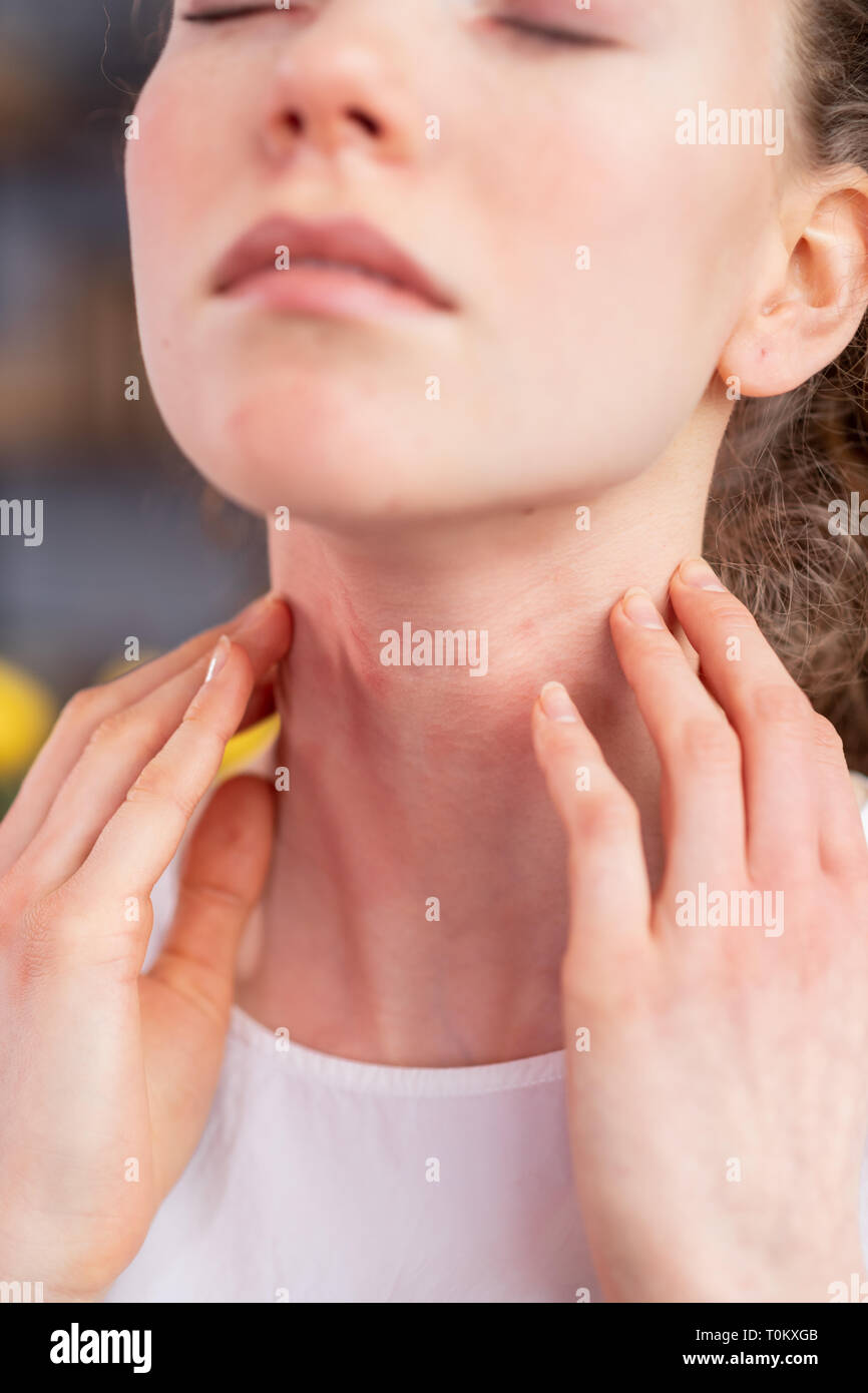 Disturb young woman closing her eyes and scratching neck Stock Photo ...