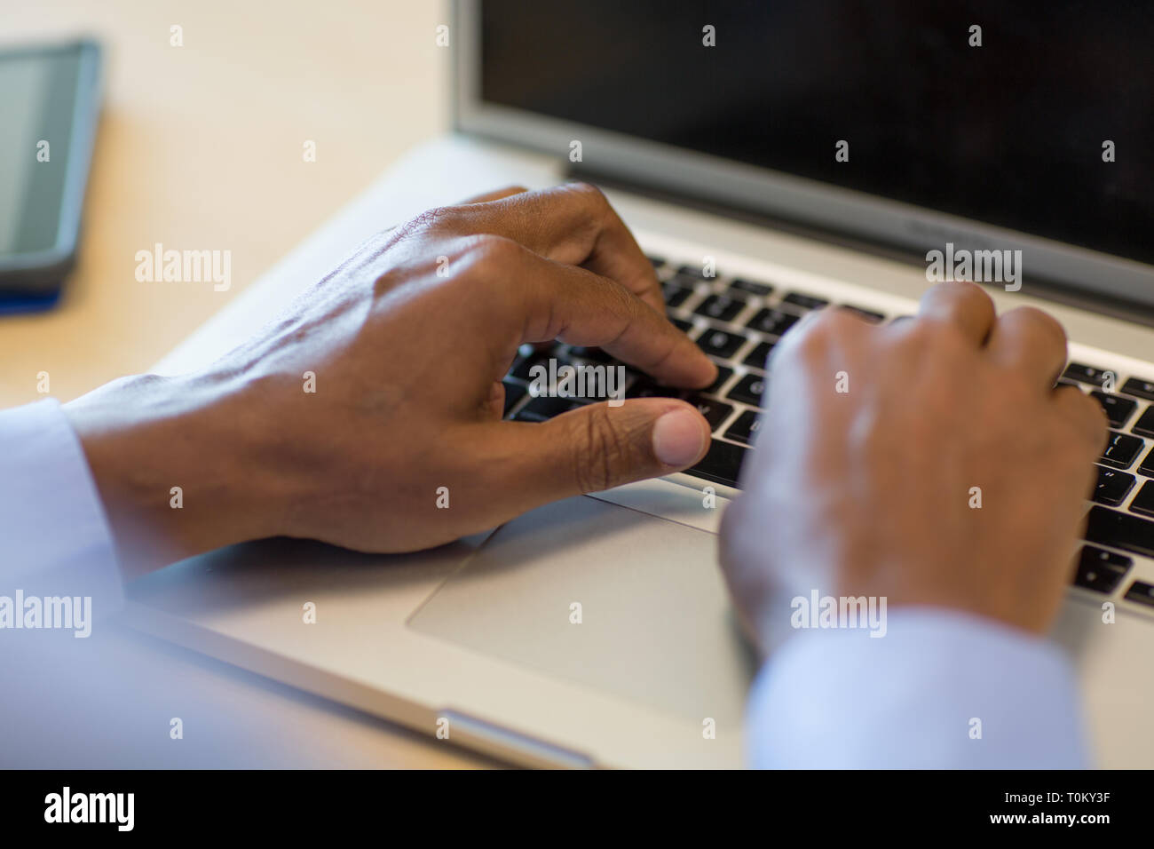 African American man at typing on a computer in the office Stock Photo ...