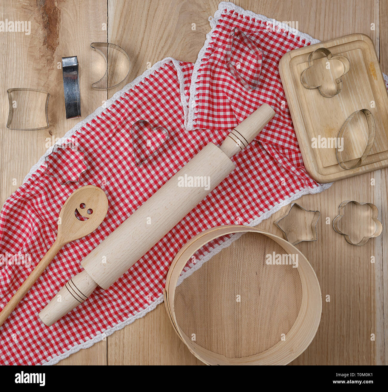 wooden sieve, rolling pin and other kitchen items on the board, top ...