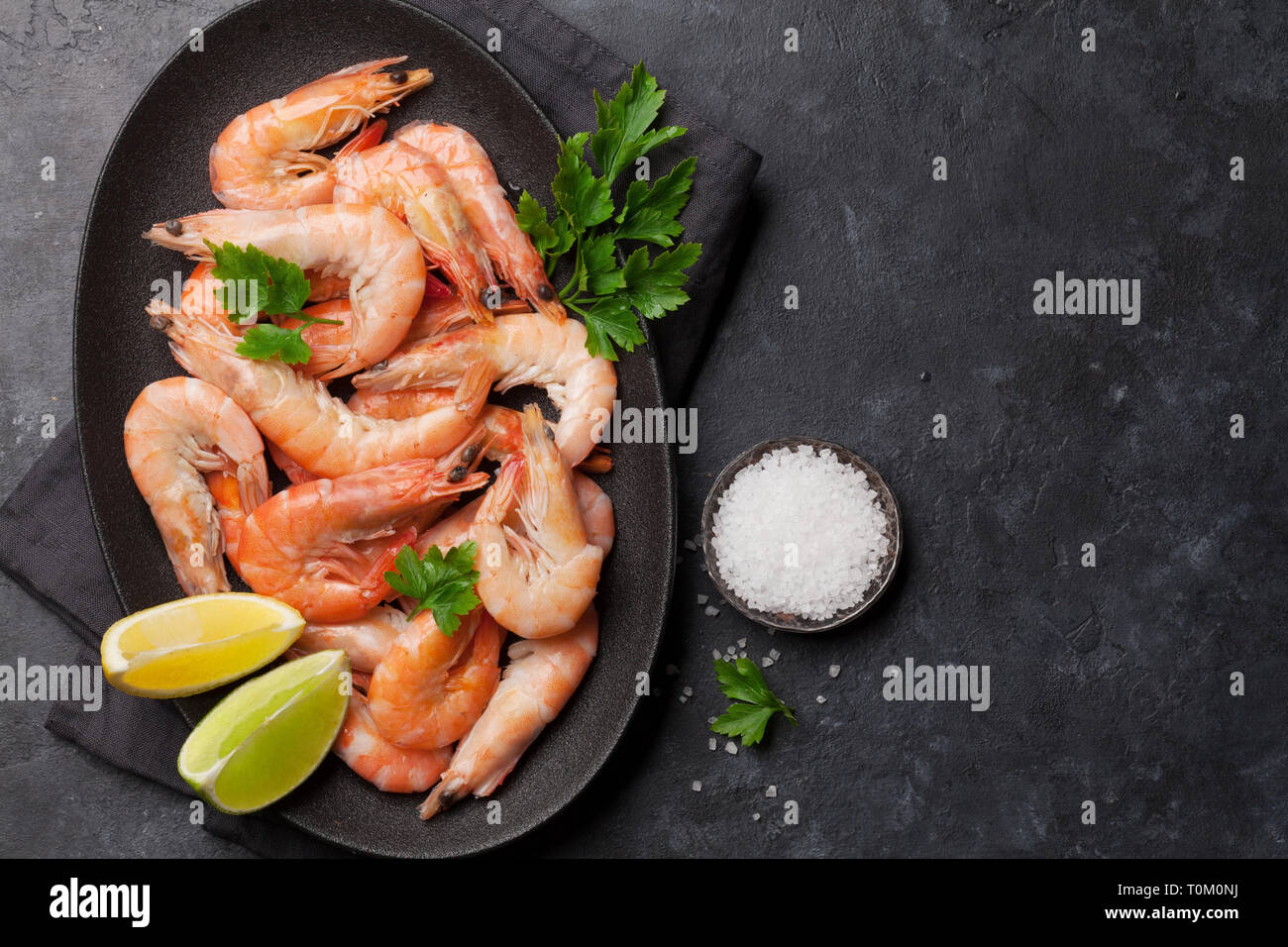 Steamed tiger shrimps with parsley and lemon. Top view with copy space ...