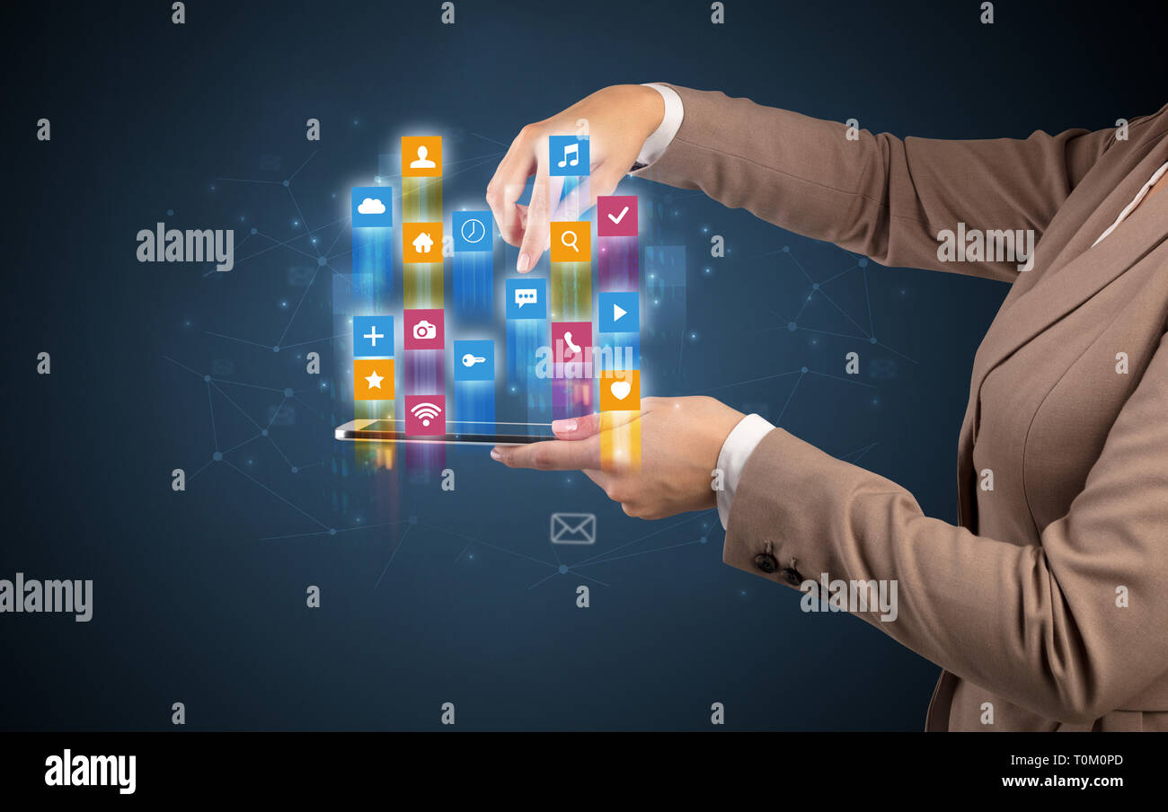 Female elegant hand holding tablet with colourful application icons ...