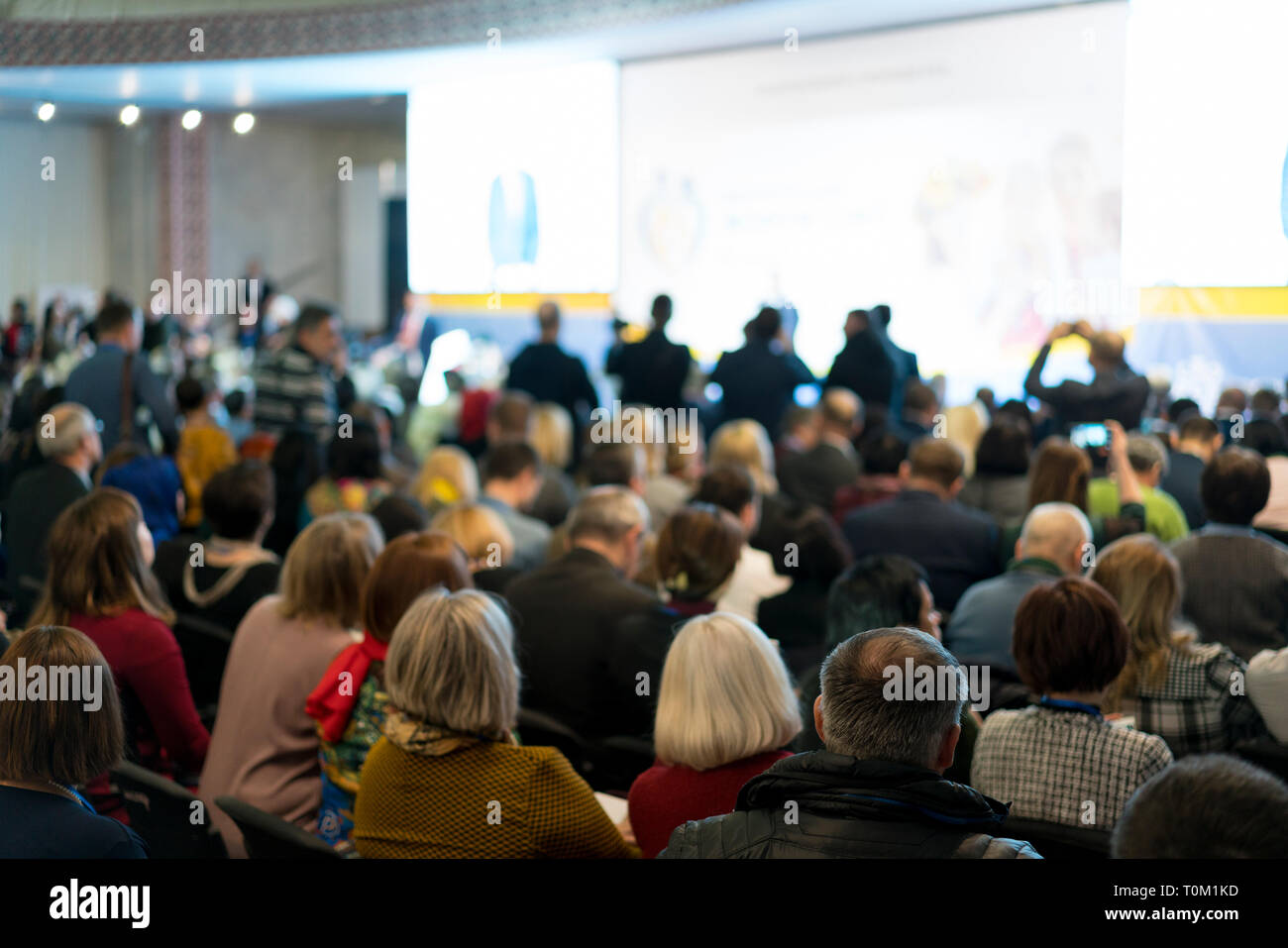 People in the hall listen to the lecturer. Businessman and people ...