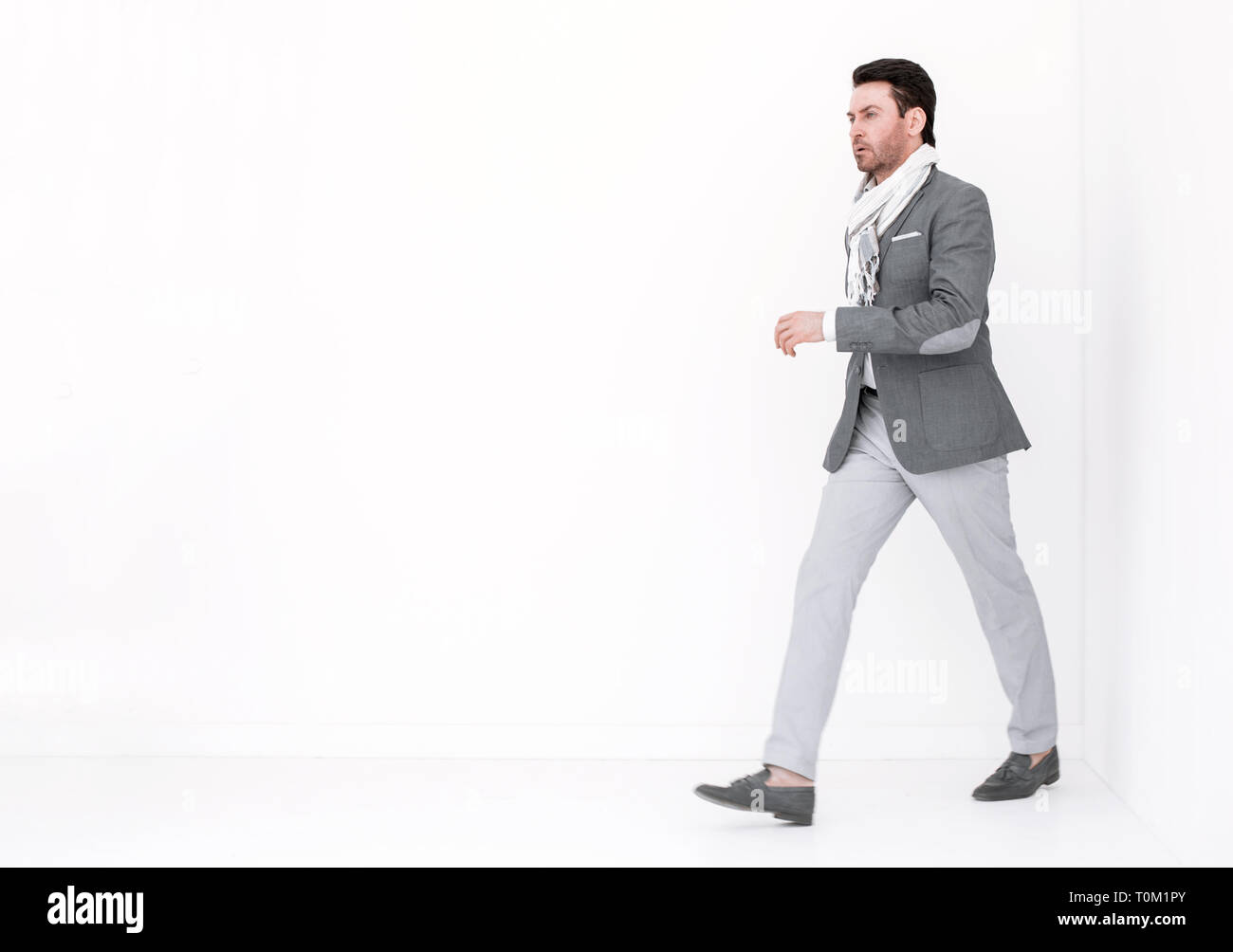 side view .business man confidently striding forward Stock Photo - Alamy