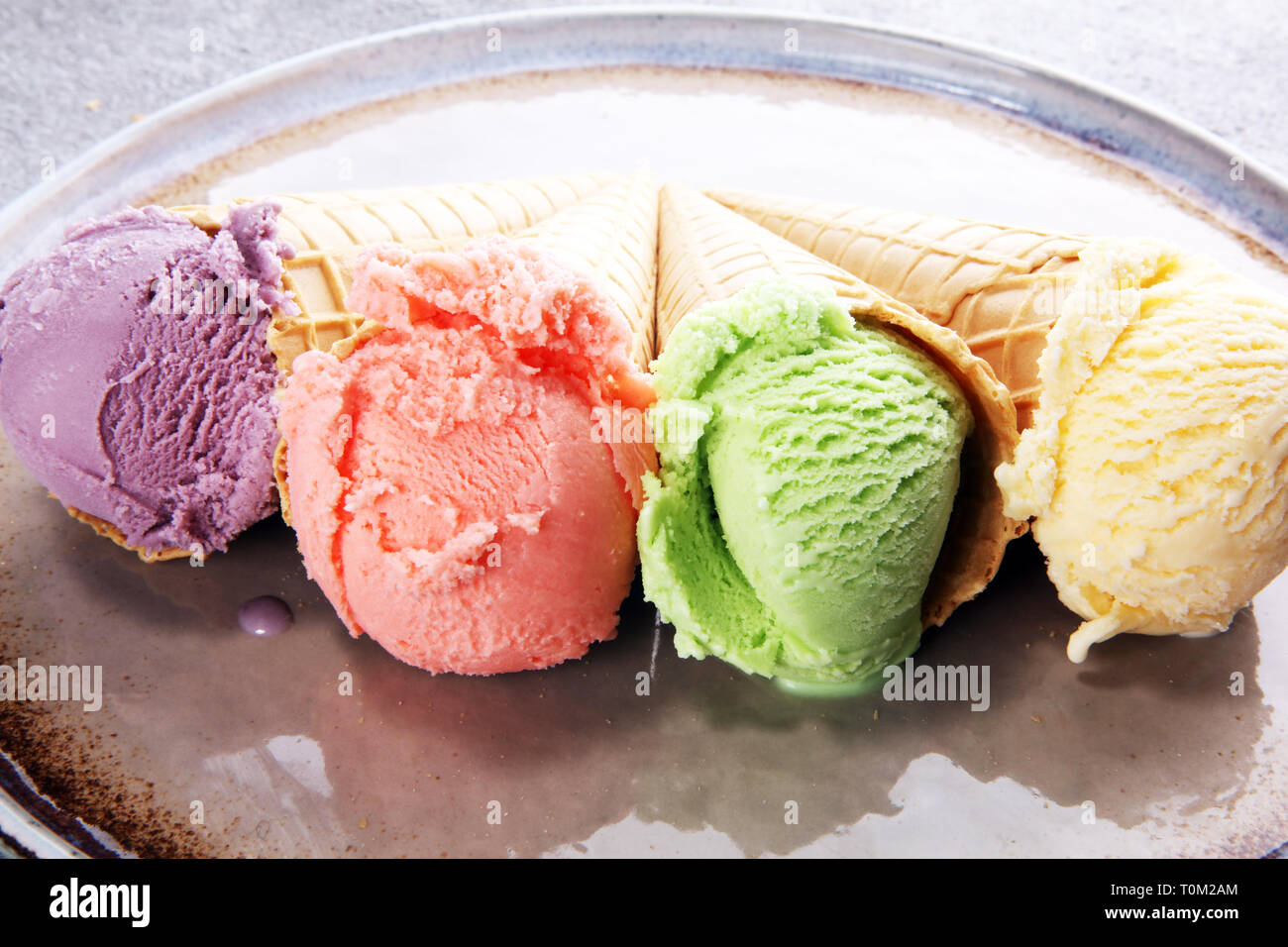 Set of ice cream scoops of different colors and flavours with berries ...