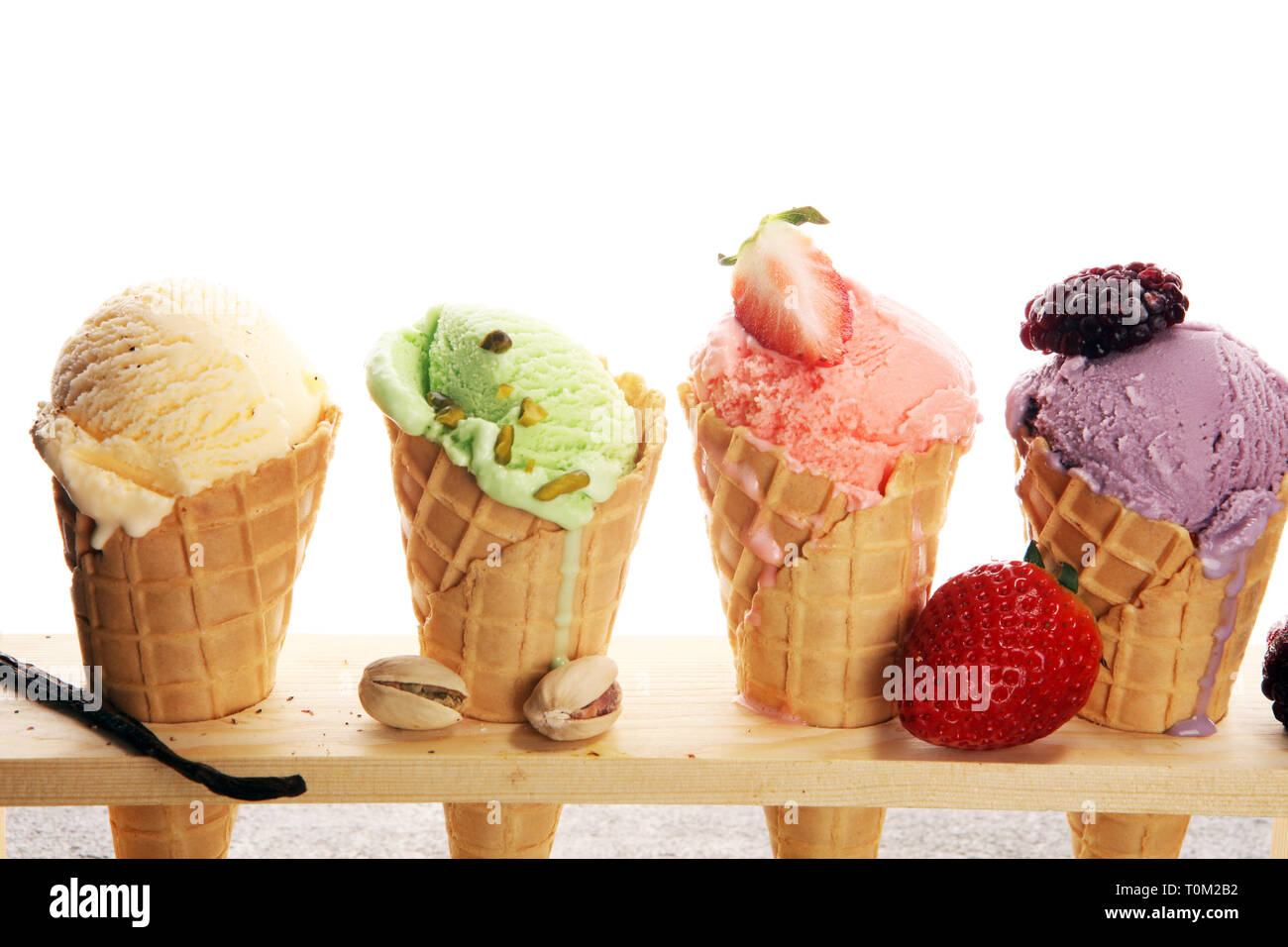 Set of ice cream scoops of different colors and flavours with berries ...