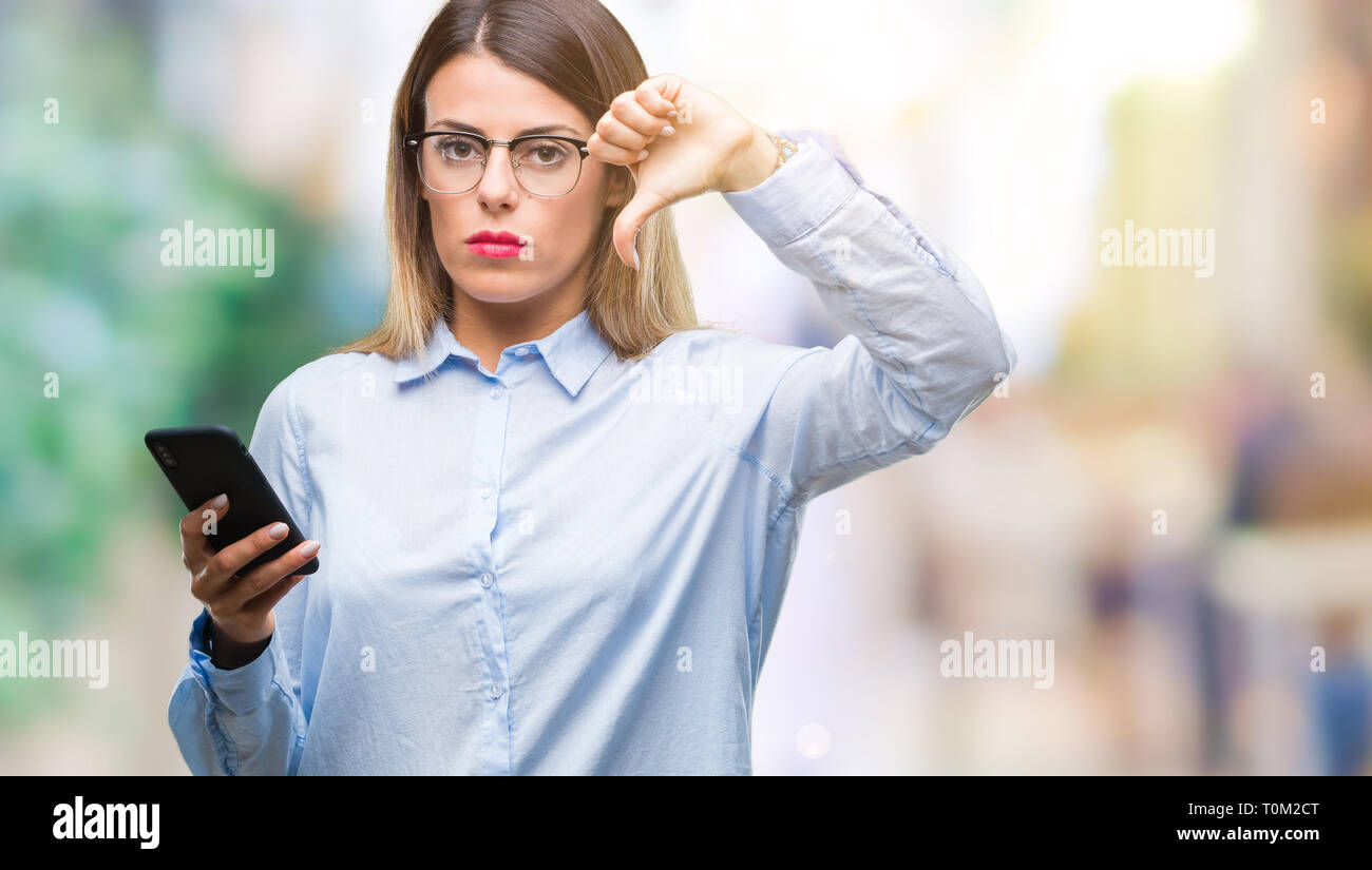 Young beautiful business woman texting message using smartphone over ...