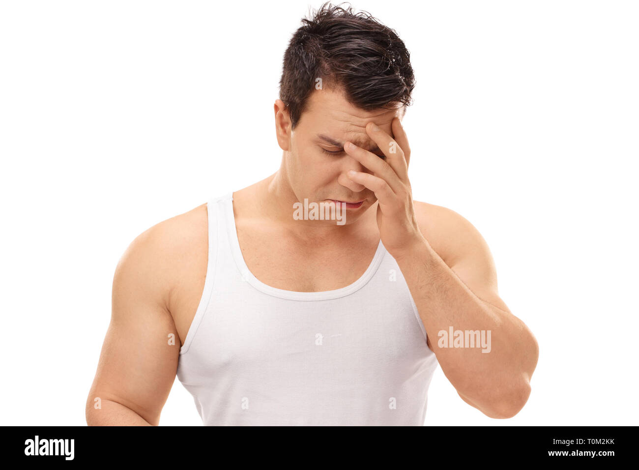 Sad young man holding his head isolated on white background Stock Photo ...