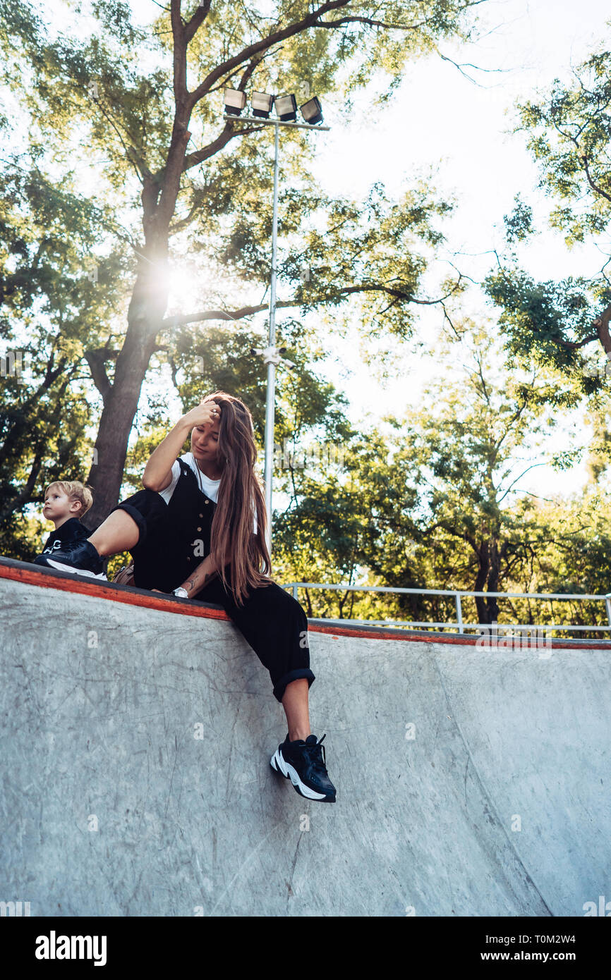 Beautiful young hipster girl sitting on the edge of a ramp Stock Photo ...