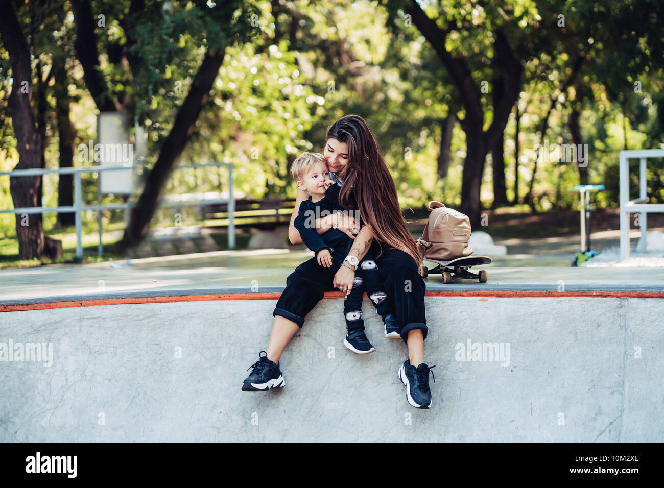 Beautiful young hipster mom and little son at the skatepark Stock Photo ...